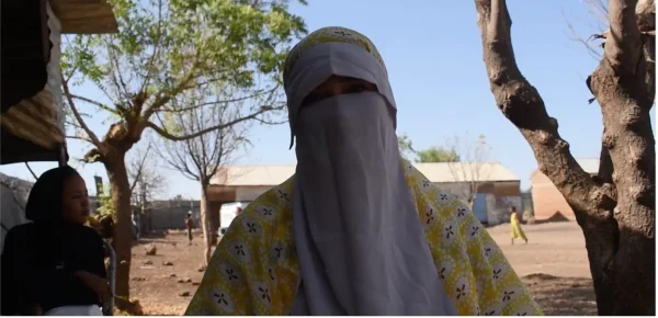 Outside her shelter in Gedaref, Sarah* shares her story of escape, loss, and the struggle to ...